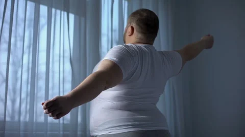 Fat man stretching back muscles, feeling... | Stock Video | Pond5