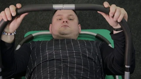 Fat man trains press on the floor in the... | Stock Video | Pond5