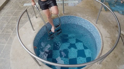 fat white guy enters a small cold pool a... | Stock Video | Pond5
