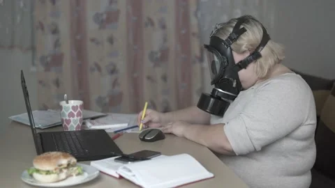 Fat woman in gas mask working at her des... | Stock Video | Pond5