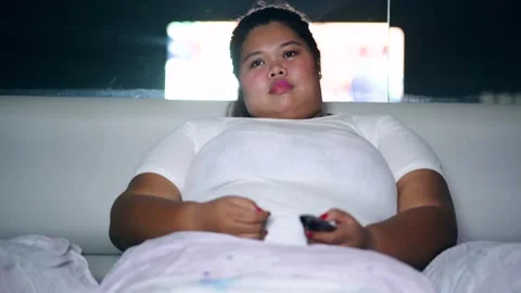 Fat woman watching television on the bed... | Stock Video | Pond5