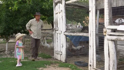 A father and a child work on a farm. Out... | Stock Video | Pond5