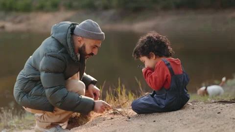Father and Son Exploring Nature by a Lak... | Stock Video | Pond5