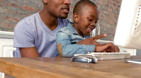Father and son using computer together | Stock Video | Pond5