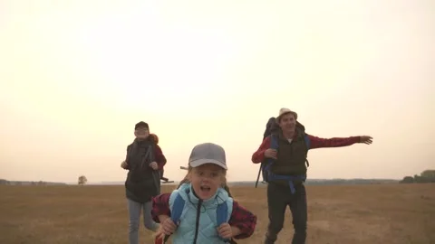 Father mother and daughter run across th... | Stock Video | Pond5