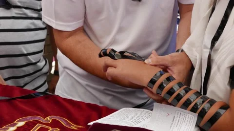 Father Wraps Tefillin on Son's Hand in 4... | Stock Video | Pond5