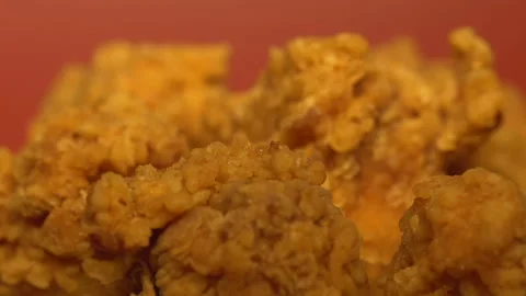 Fatty crispy fried chicken on red backgr... | Stock Video | Pond5