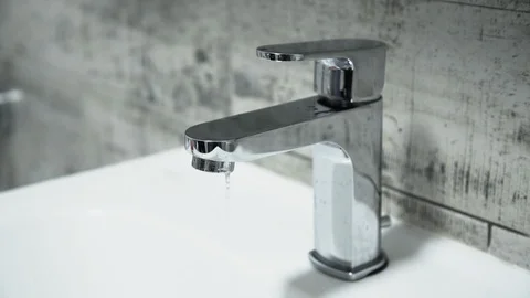 Faucet with dripping water drops on tile... | Stock Video | Pond5
