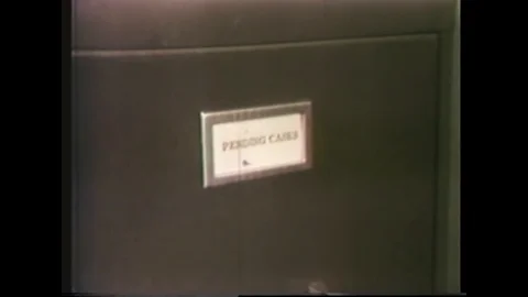An FBI agent pulls a file from a filing ... | Stock Video | Pond5