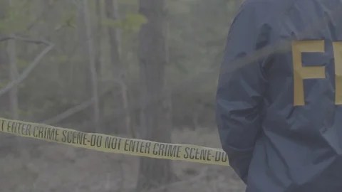 FBI Agent Standing by Crime scene Behind | Stock Video | Pond5