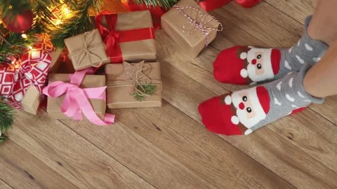 feet in funny Christmas socks Santa face... | Stock Video | Pond5