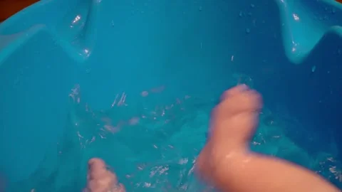 feet of a newborn baby splash in a blue ... | Stock Video | Pond5