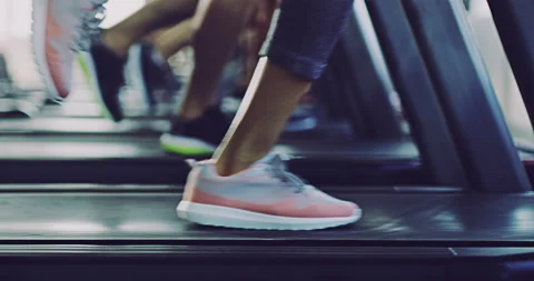 Feet running on a treadmill machine toge... | Stock Video | Pond5