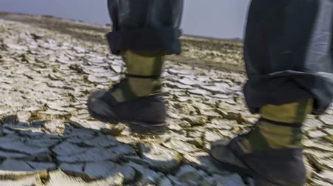 Feet Of Scientist Walking On Cracked Des... | Stock Video | Pond5