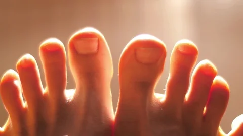 Feet with toes moving, relaxing. Closeup... | Stock Video | Pond5