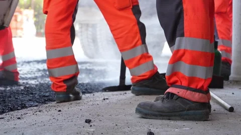 feet of unknown construction workers spr... | Stock Video | Pond5