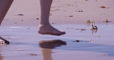 Feet walking into ocean - close up slow ... | Stock Video | Pond5