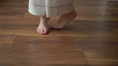 Feet on a wooden floor. Young woman bare... | Stock Video | Pond5