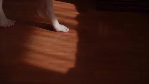 Feet on a wooden floor. Young woman bare... | Stock Video | Pond5