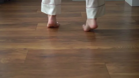 Feet on a wooden floor. Young woman bare... | Stock Video | Pond5