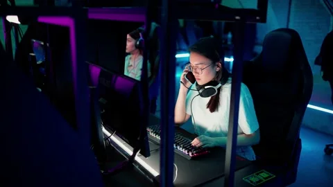 Female Asian woman gamer talking on mobi... | Stock Video | Pond5