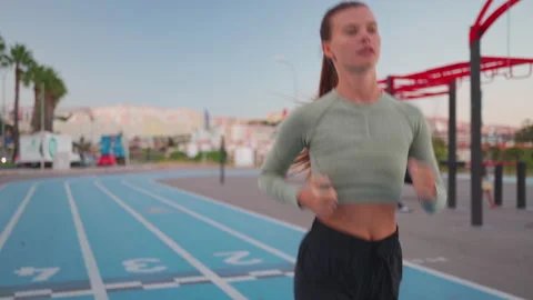 Female athlete running on the track | Stock Video | Pond5