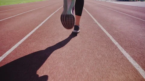 Female athlete running on track in slow ... | Stock Video | Pond5