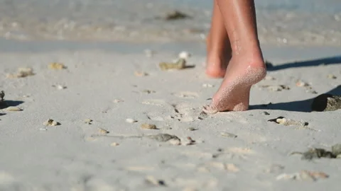 Female barefoot walk sand beach close up... | Stock Video | Pond5