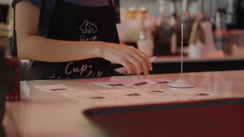 Female Barista Sorting Order Forms On Th... | Stock Video | Pond5