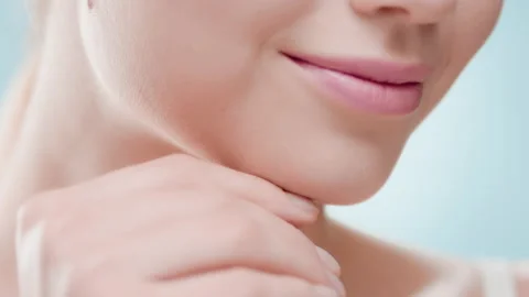 Female beauty model touches her jawline ... | Stock Video | Pond5