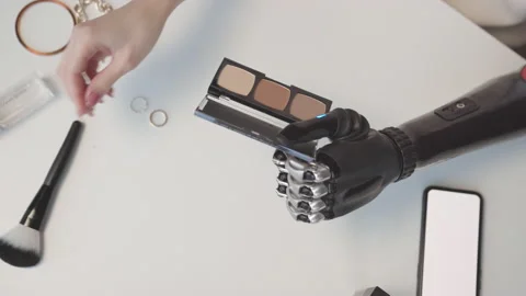 Female with Bionic Arm Doing Makeup | Stock Video | Pond5