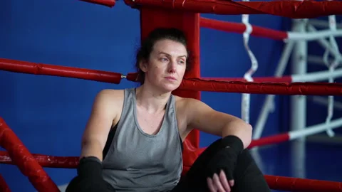 Female boxer sitting in corner of boxing... | Stock Video | Pond5