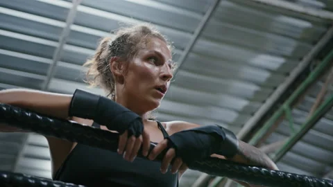 Female boxer wet with sweat takes a deep... | Stock Video | Pond5