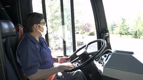 Female bus driver in face mask driving p... | Stock Video | Pond5