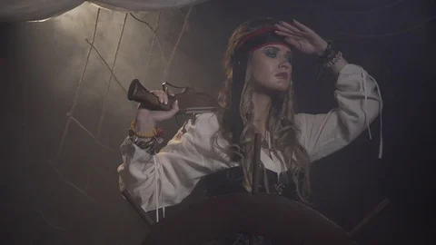 Female captain of the pirate ship is loo... | Stock Video | Pond5