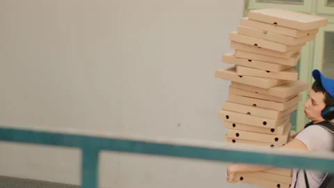 Female carrier trying to catch falling p... | Stock Video | Pond5