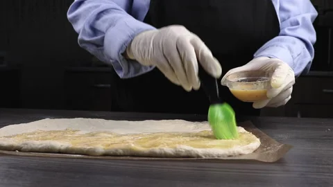 female chef greasing dough with egg yolk... | Stock Video | Pond5