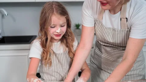 female child cooking with parent, cute l... | Stock Video | Pond5