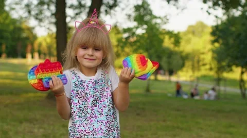 Female child girl showing push pop it bu... | Stock Video | Pond5