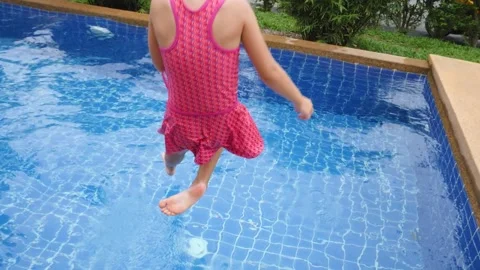Female child jump and swim in swimming p... | Stock Video | Pond5