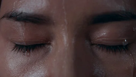 Female closed eyes under the rain | Stock Video | Pond5