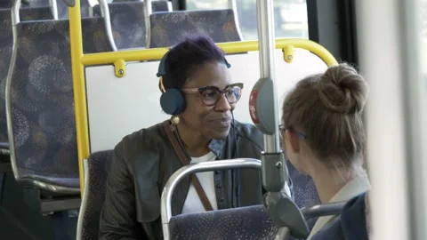 Female commuters talking on public bus | Stock Video | Pond5