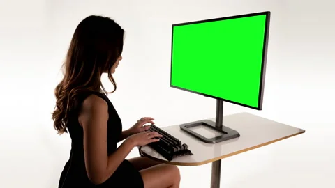 Female on a computer with green screen | Stock Video | Pond5