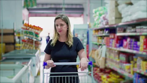 Female consumer walking in supermarket a... | Stock Video | Pond5