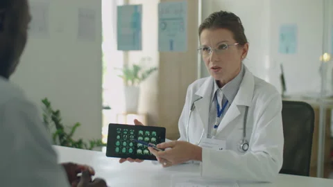 Female Doctor Explaining Brain CT Scan t... | Stock Video | Pond5