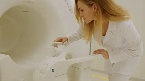 A female doctor sets up a modern MRI mac... | Stock Video | Pond5
