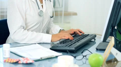 Female doctor working on computer and ch... | Stock Video | Pond5