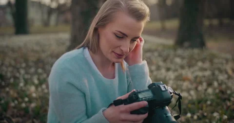 Female explorer with camera sitting in p... | Stock Video | Pond5