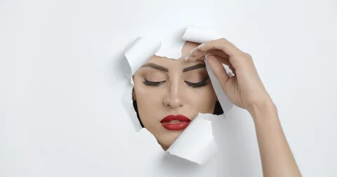 Female Face in Paper Hole | Stock Video | Pond5