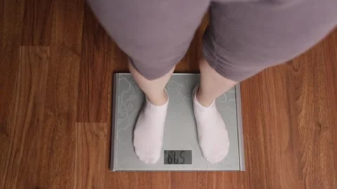 Female feet step on scales, weight measu... | Stock Video | Pond5